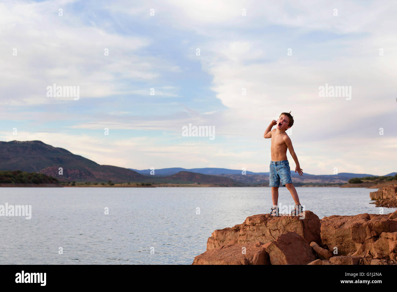 Boy standing on rock screaming hi-res stock photography and images - Alamy