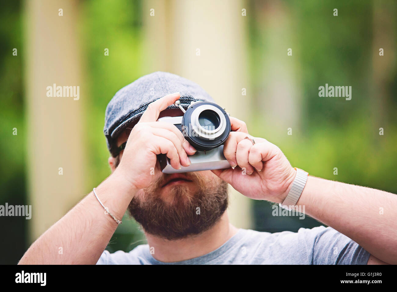 Young stylish hipster photographer with vintage camera Stock Photo - Alamy