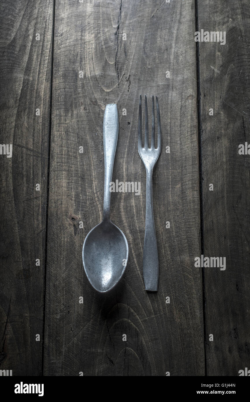 Old cutlery on wooden table, from above Stock Photo - Alamy