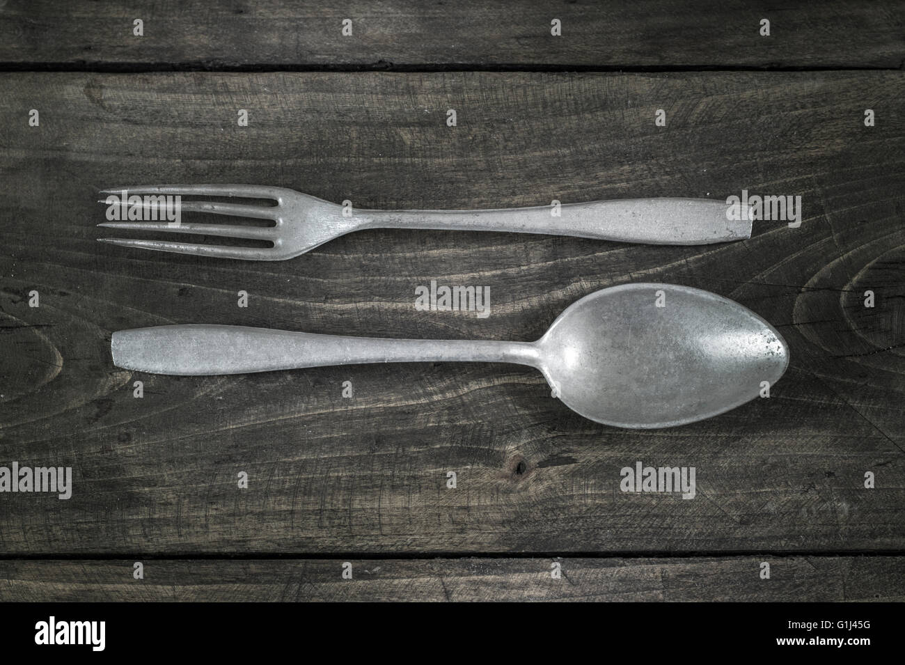 Old cutlery on wooden table, from above Stock Photo - Alamy