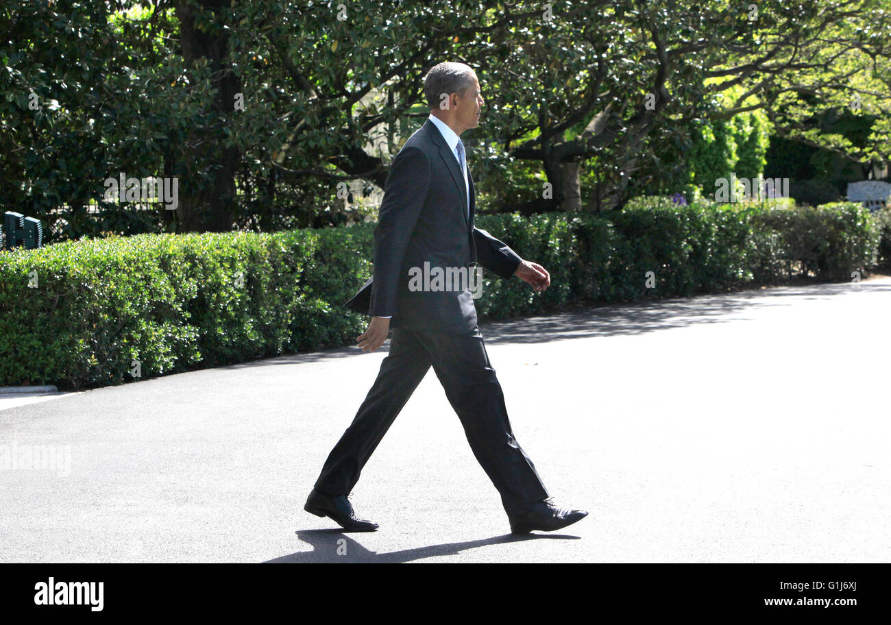 United States President Barack Obama walks across the driveway as he ...