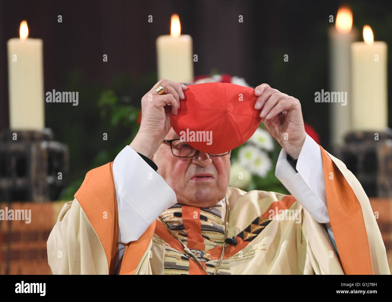 The parting Bishop of Mainz, Cardinal Karl Lehmann, puts on his ...