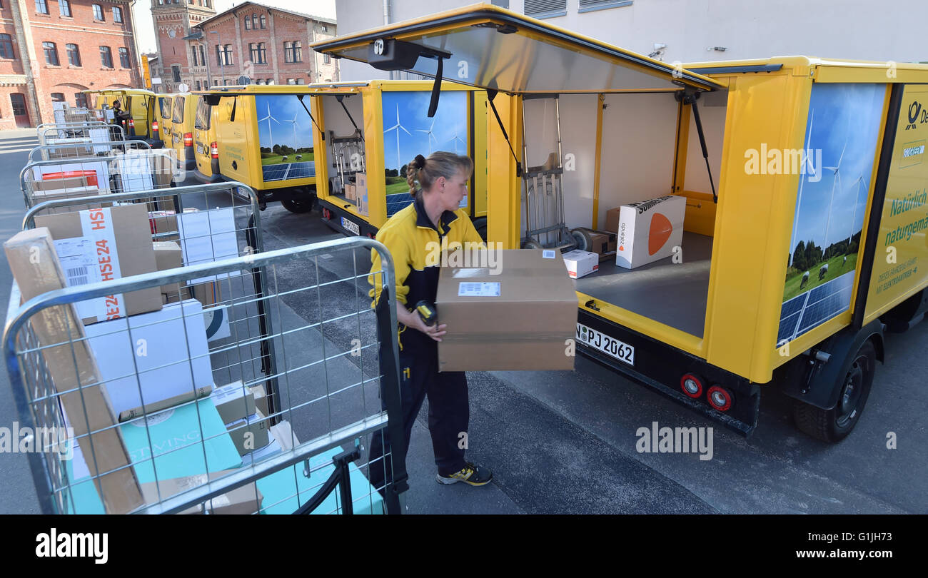 Mailwoman Sabine Kaufmann loads a new electro delivery truck of the ...