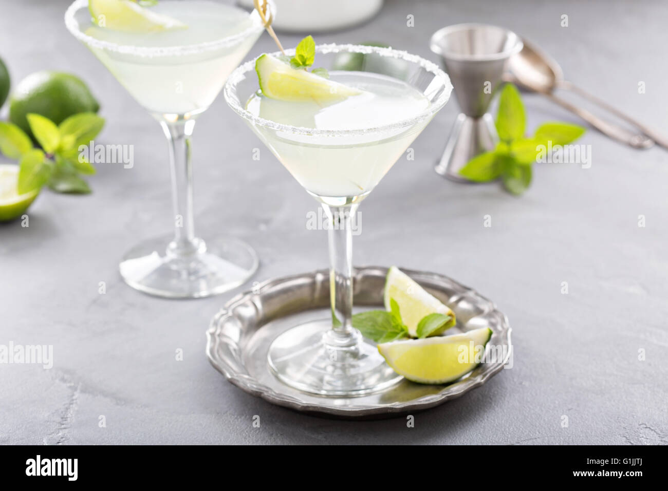 Lemonade martini cocktail garnished with lime Stock Photo - Alamy