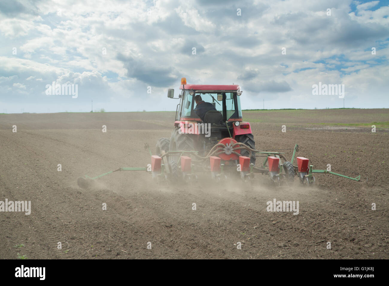 Farmer sowing crops at field Stock Photo - Alamy