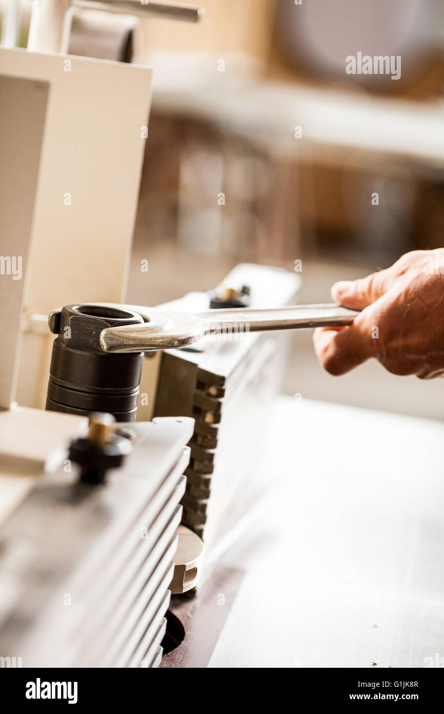 detail of a hand of a woodworker setting up a milling cutter Stock ...