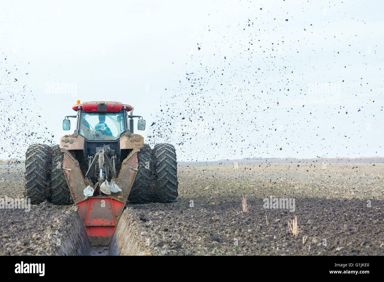 Tractor with double wheeled ditcher digging drainage canal Stock Photo - Alamy