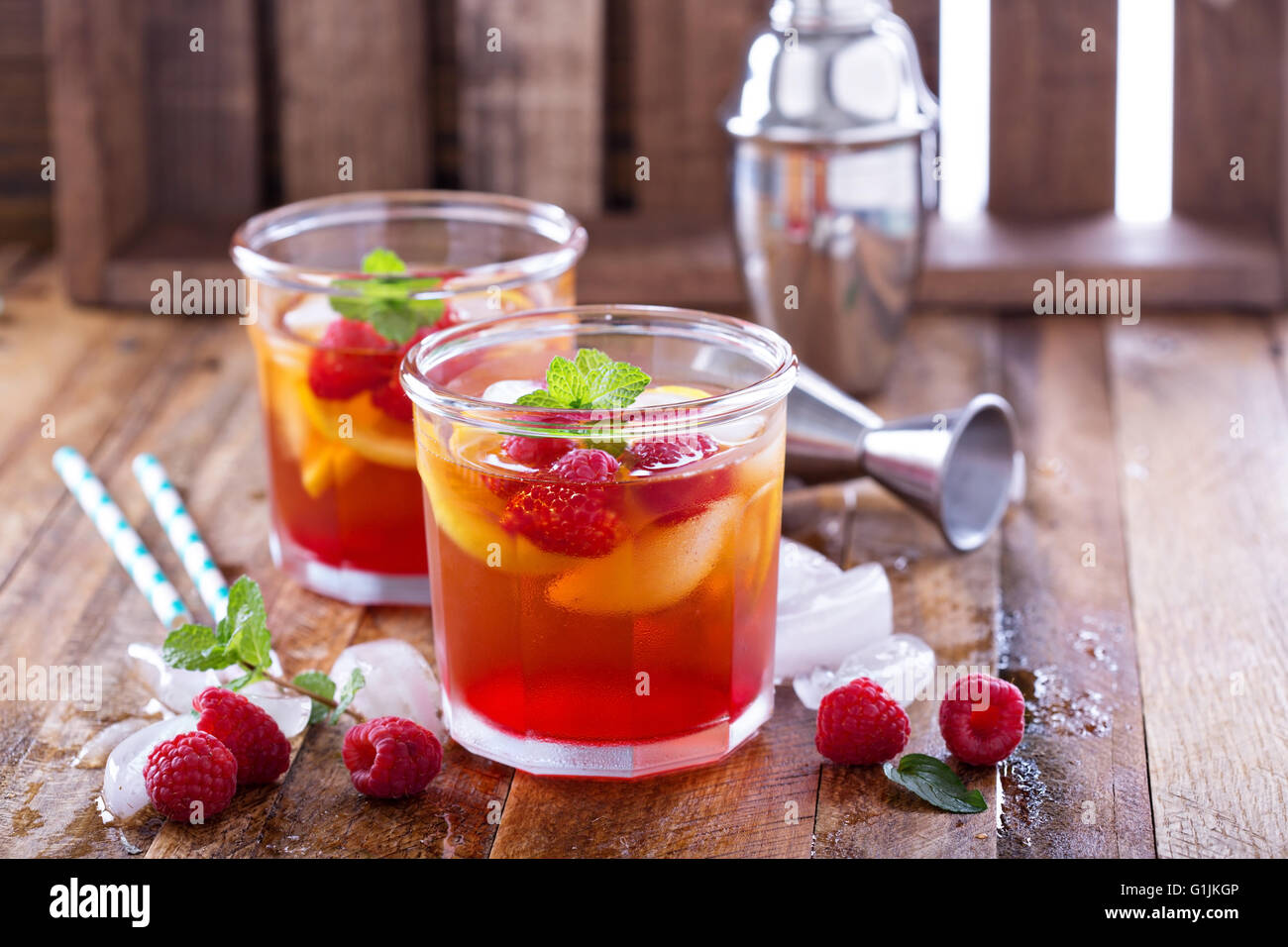 Red summer cocktail with lemons and raspberry Stock Photo - Alamy