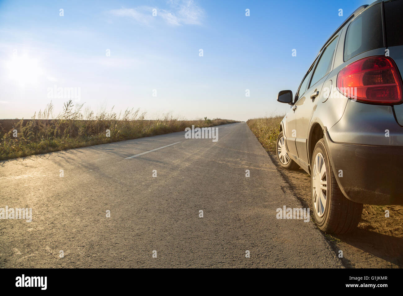 Car parked on a side of road Stock Photo - Alamy