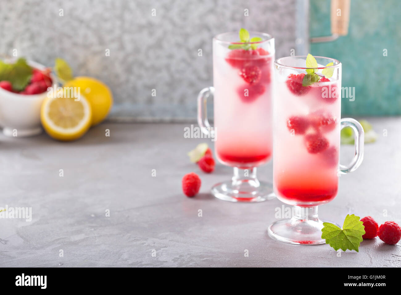 Pink raspberry lemonade in tall glasses Stock Photo - Alamy