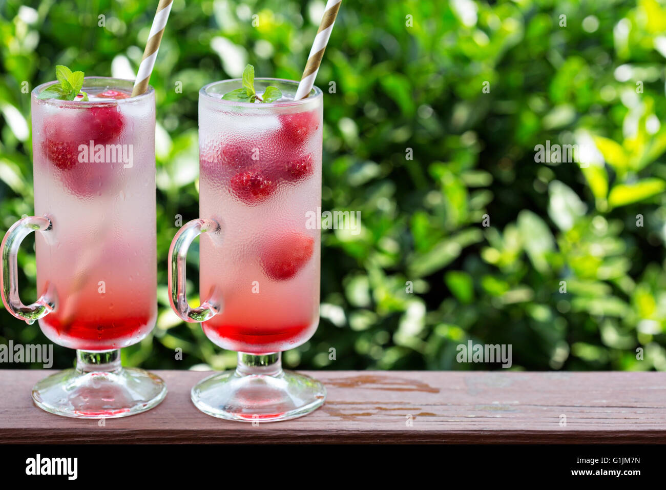 Pink raspberry lemonade in tall glasses Stock Photo - Alamy