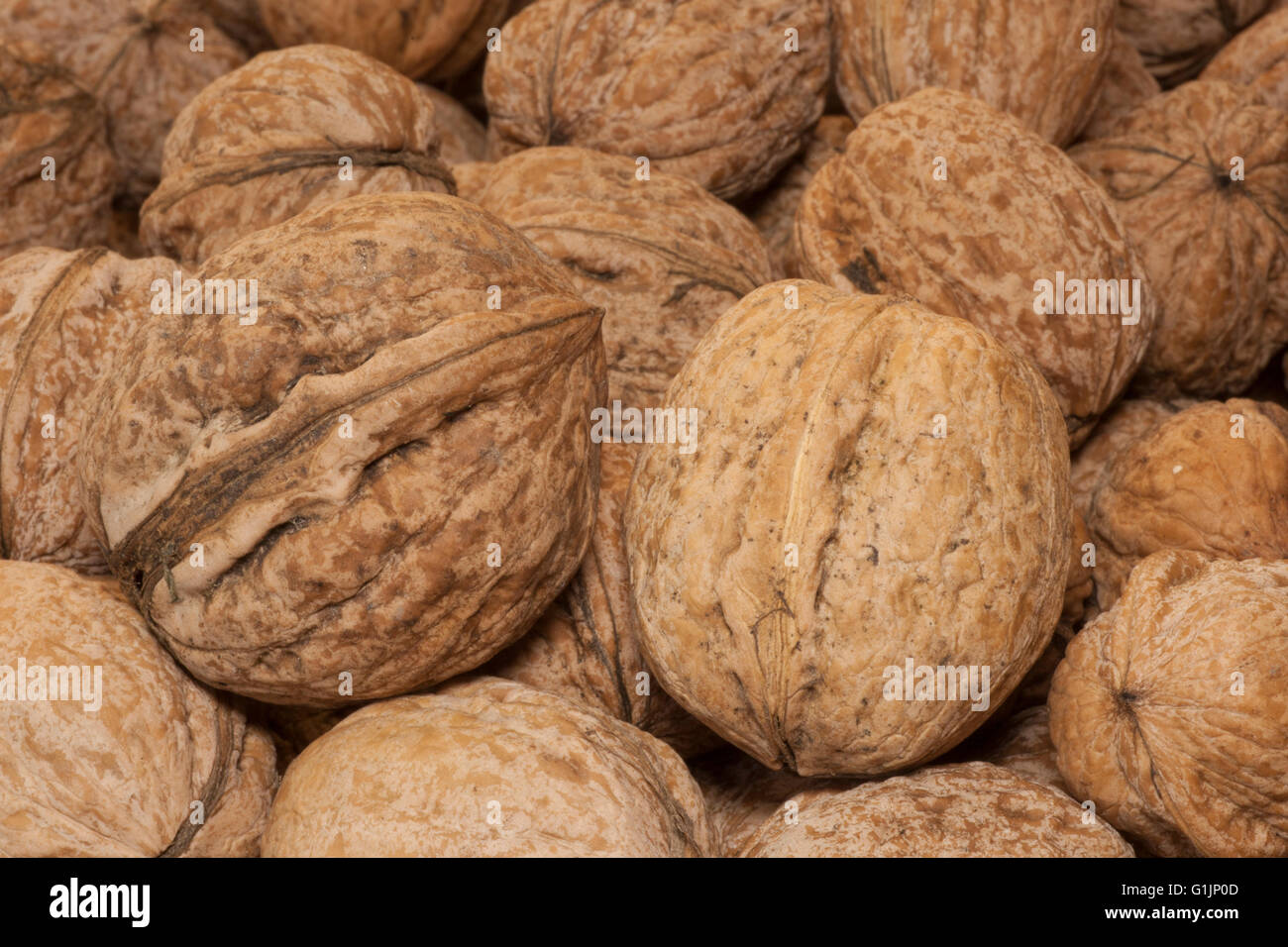 Heap of walnuts on table Stock Photo - Alamy