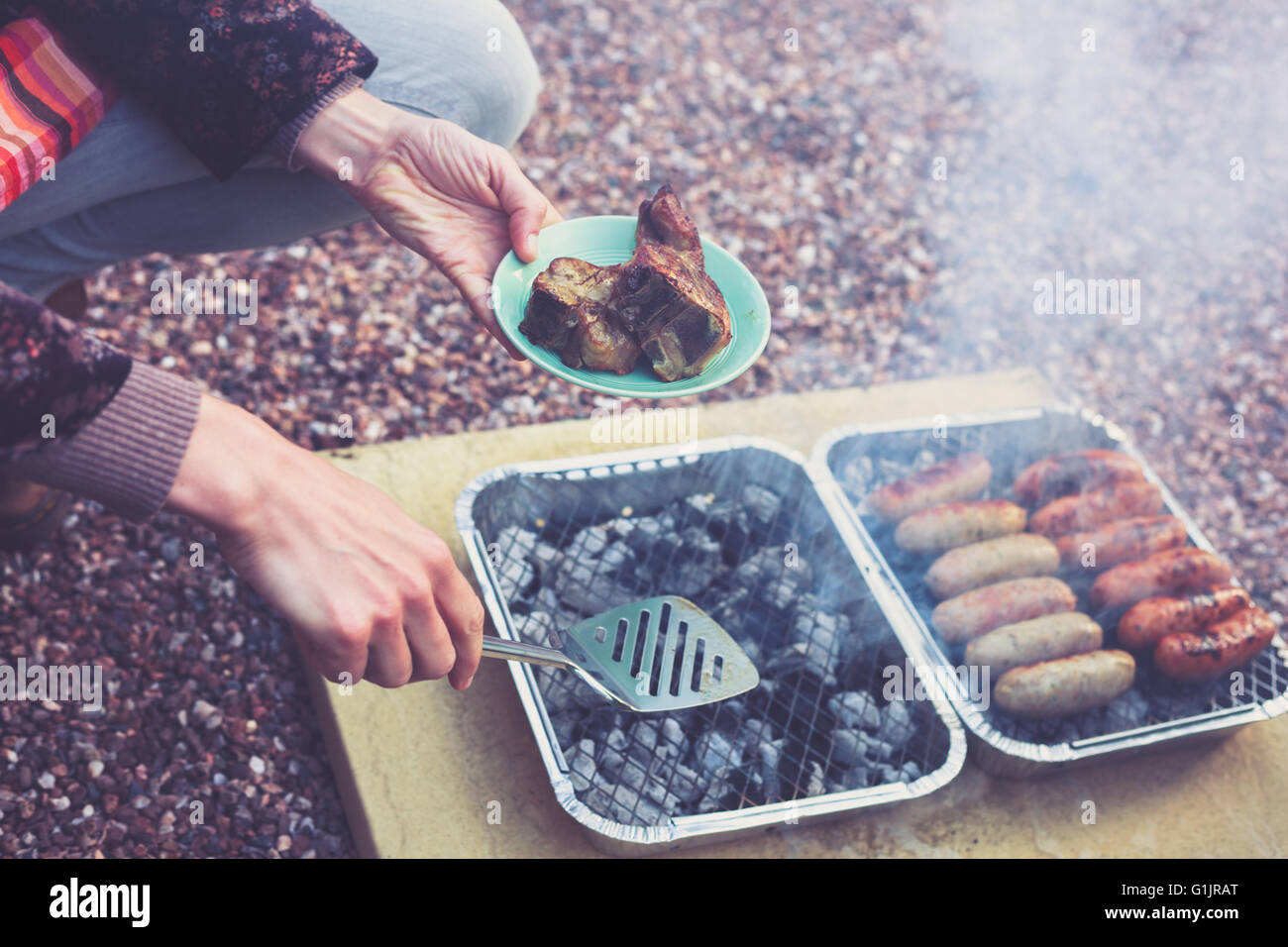 Young woman cooking on barbecue hi-res stock photography and images - Alamy