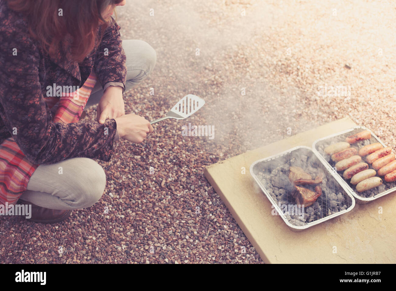 Woman barbecuing meat hi-res stock photography and images - Alamy