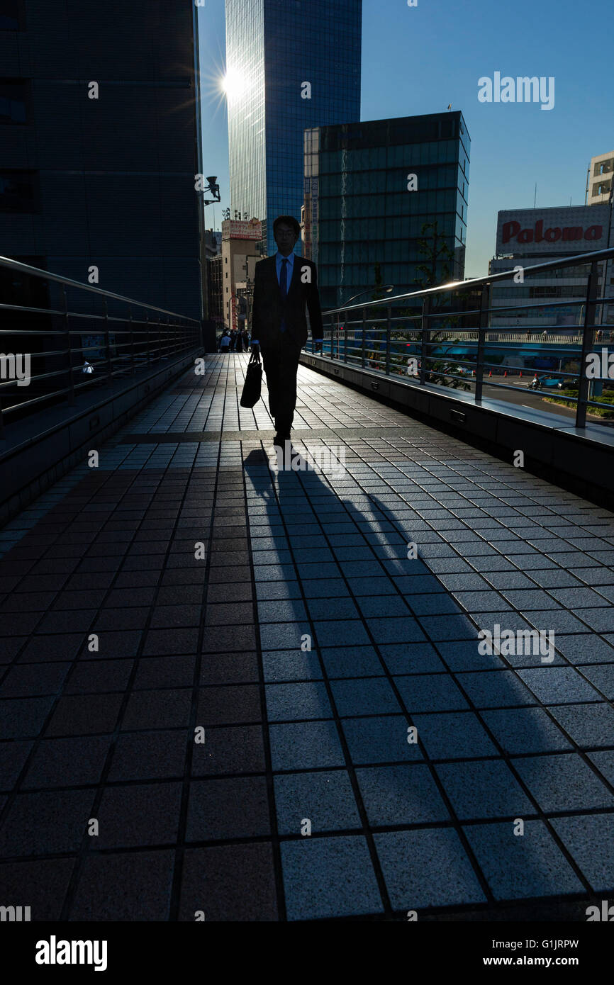 Business man walking home after work Stock Photo - Alamy