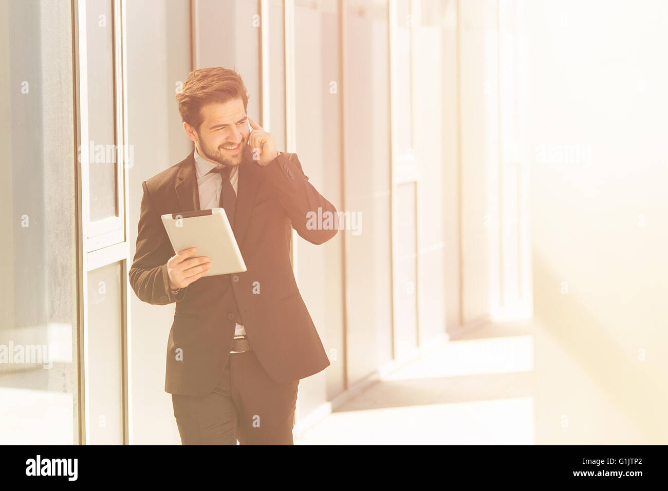Businessman speaking over phone Stock Photo - Alamy