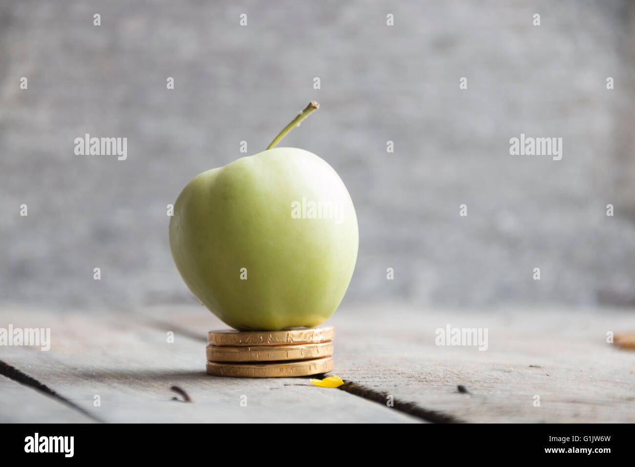 gold coins and apple Stock Photo - Alamy