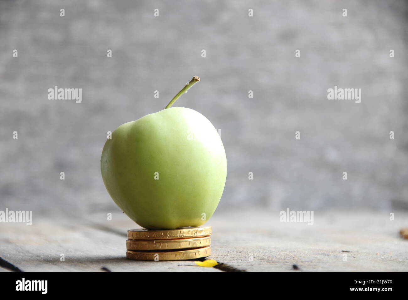 gold coins and apple Stock Photo - Alamy