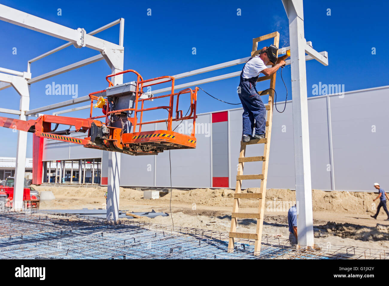 Construction worker is welding metal frame without proper safety ...