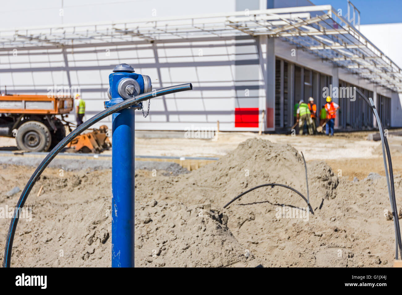 Newly placed fire hydrant with blue pipe is at construction site Stock ...