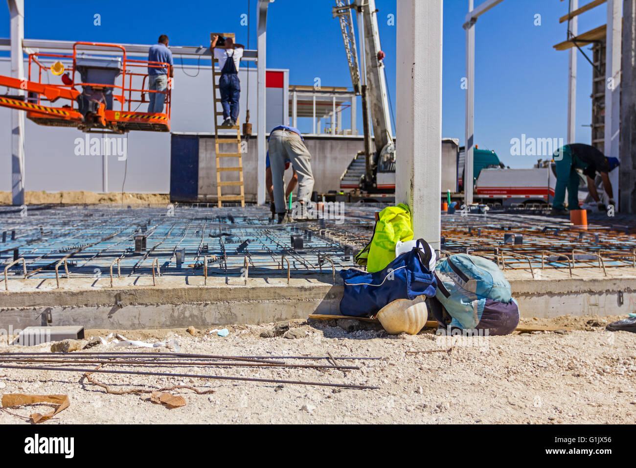 Pile of backpacks with and helmet on the construction site ...