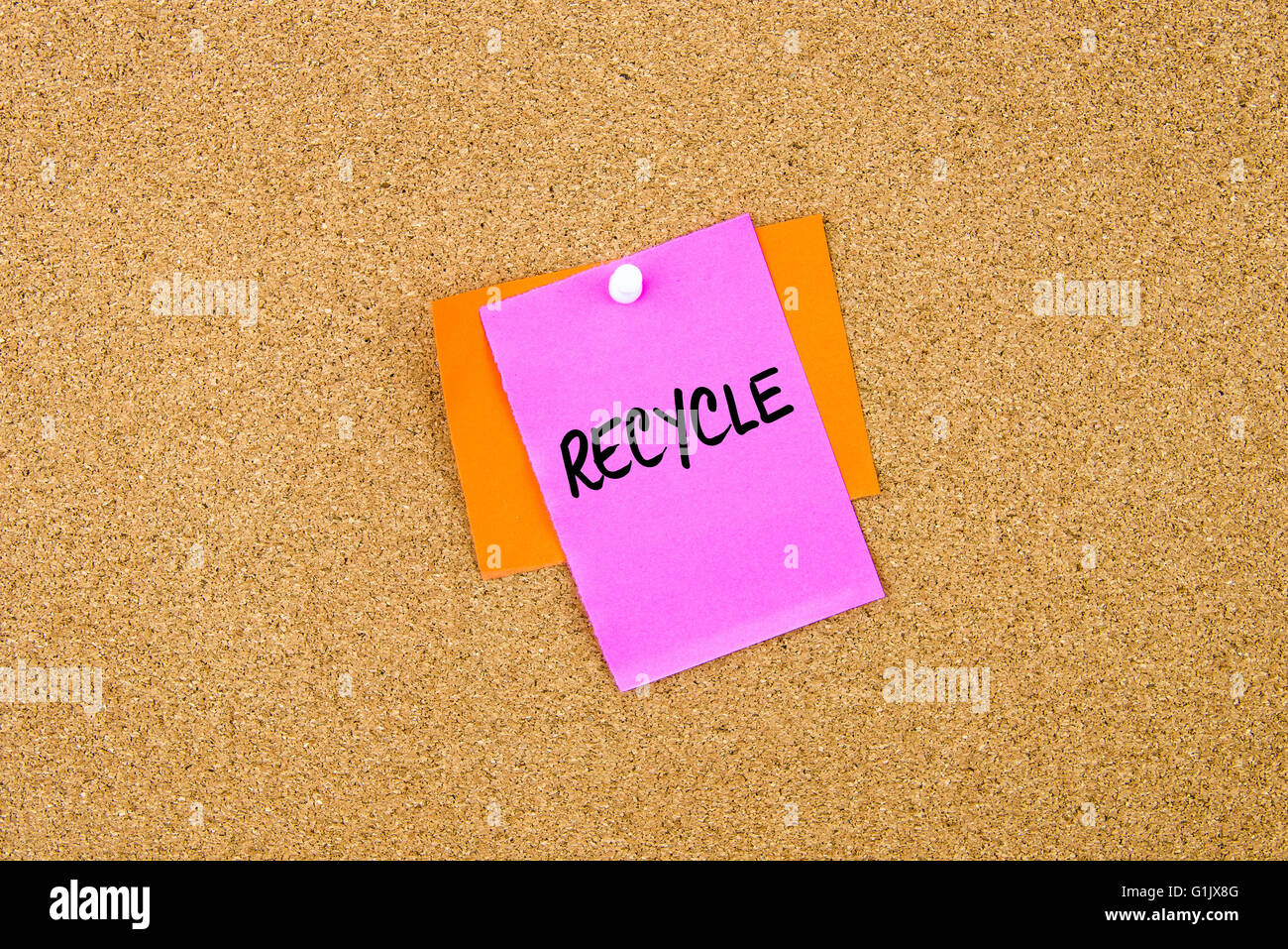 RECYCLE written on paper note pinned on cork board with white thumbtack ...
