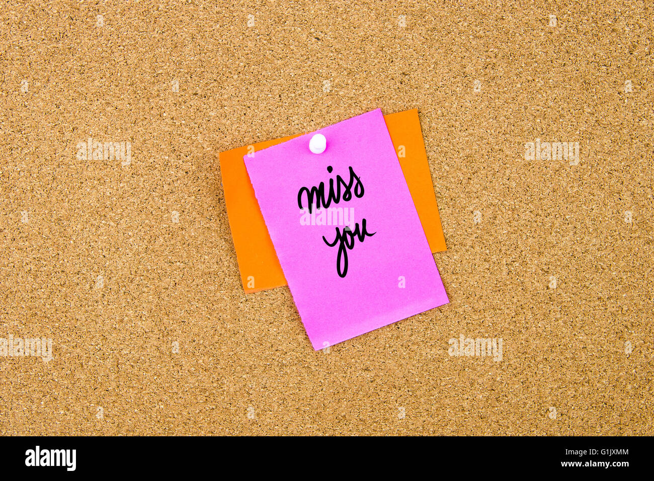 Miss You written on paper note pinned on cork board with white ...