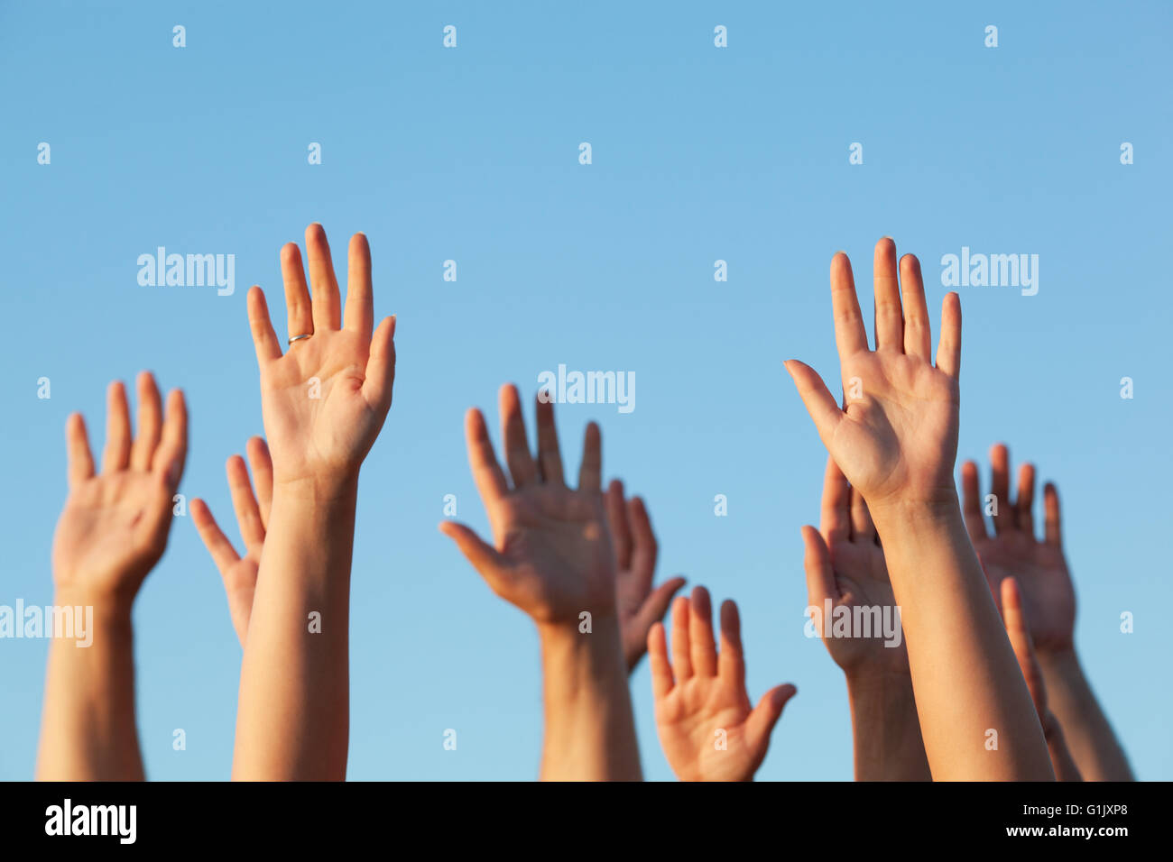 Group of people raising their hands in the air Stock Photo - Alamy