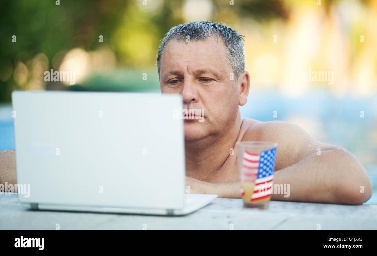 Man in Swimming Pool with Laptop and Beverage Stock Photo - Alamy