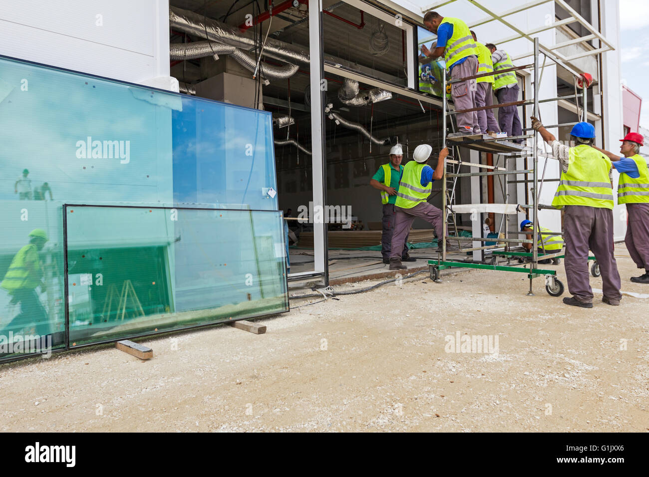 Team of construction workers are installing double glass window on ...