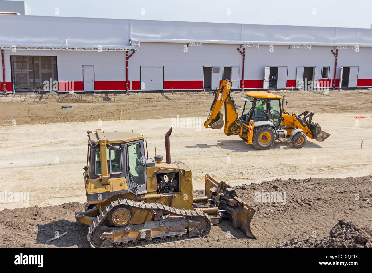 Earthmover with caterpillar is moving earth outdoors Stock Photo - Alamy