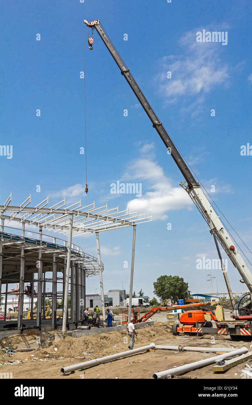 Crane is preparing to lift up frame of new canopies Stock Photo - Alamy