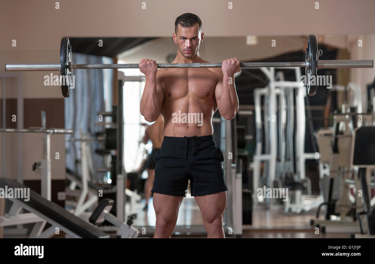handsome young muscular man doing exercises in a fitness gym Stock ...