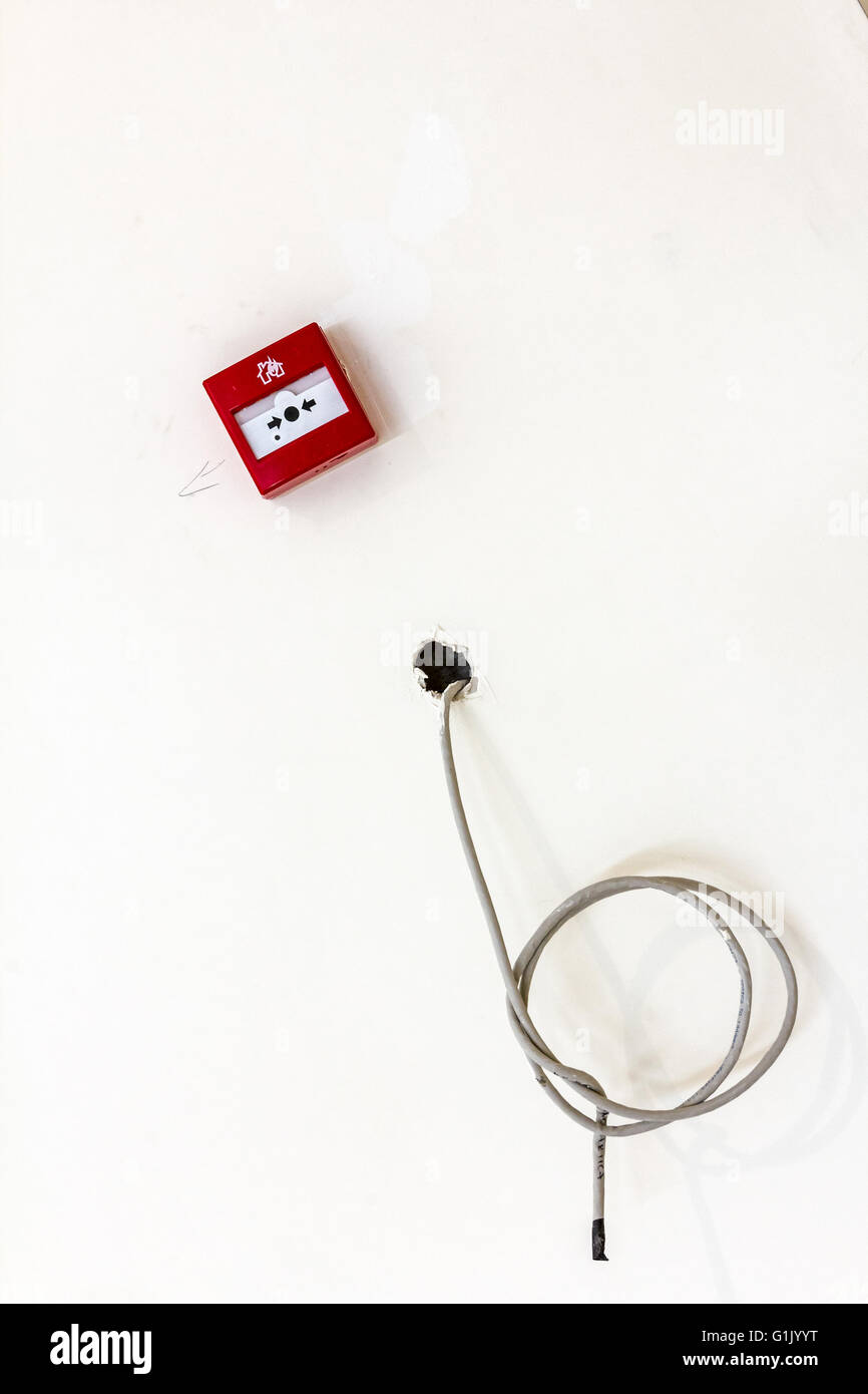 Red fire alarm panel box is on the wall, to smash glass and press ...