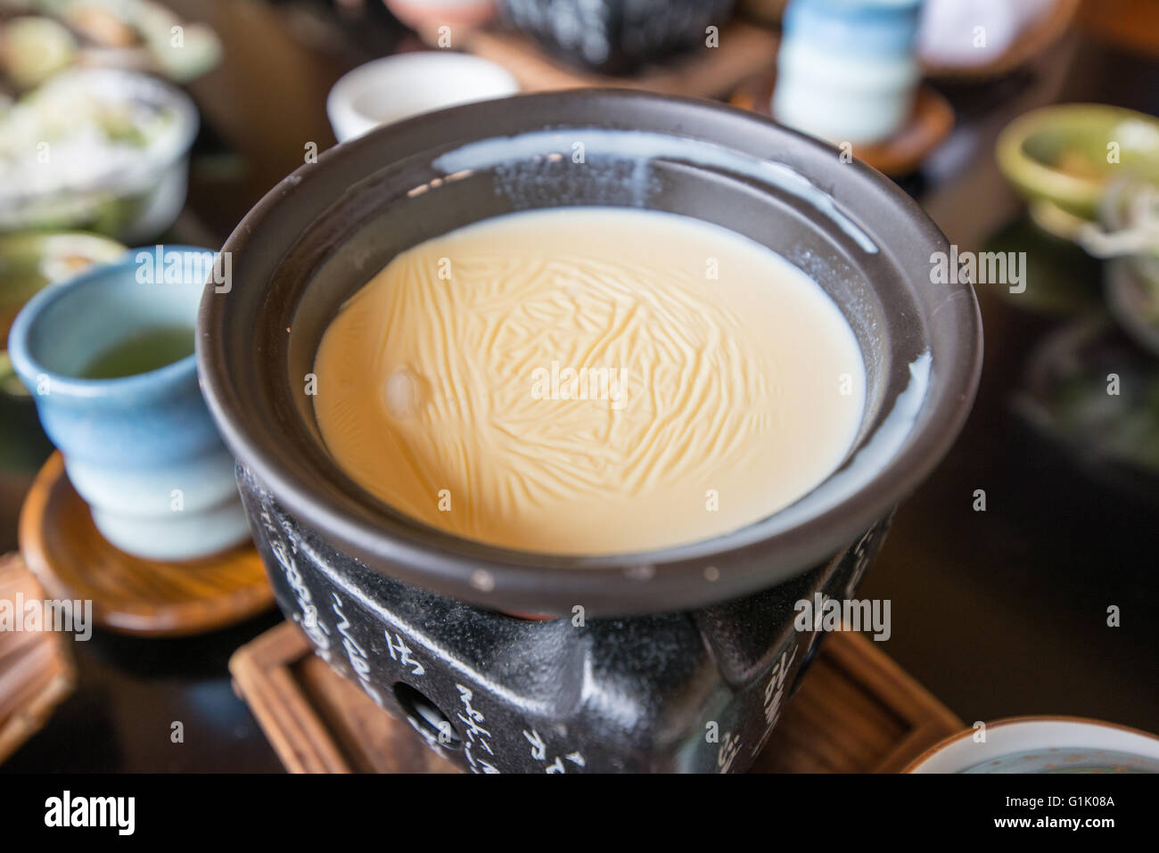 A single dish of Tofu cooking over a heated lit candle Stock Photo - Alamy