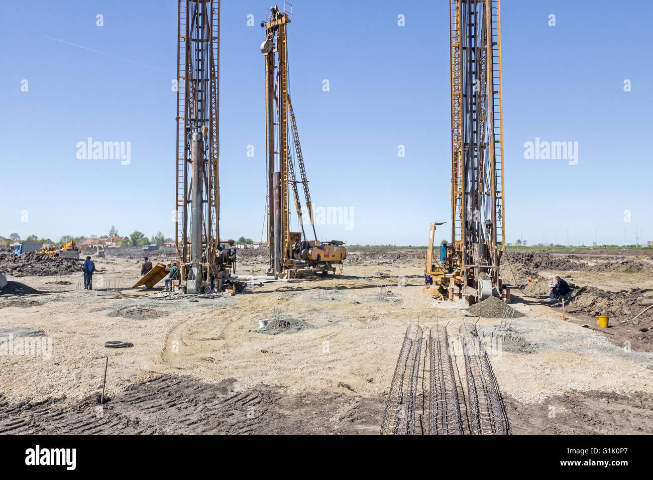 Workers are managing pile driving machines in construction site Stock ...