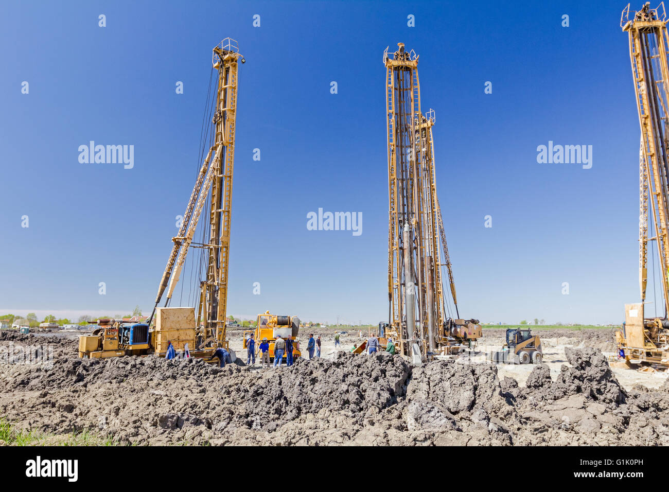 Workers are managing pile driving machines in construction site Stock ...