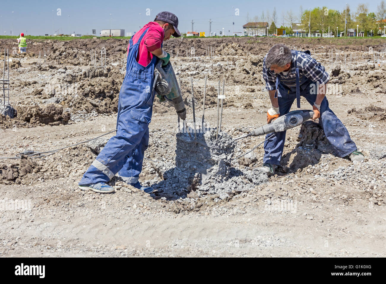 Construction workers are holding jackhammer and breaking reinforced ...
