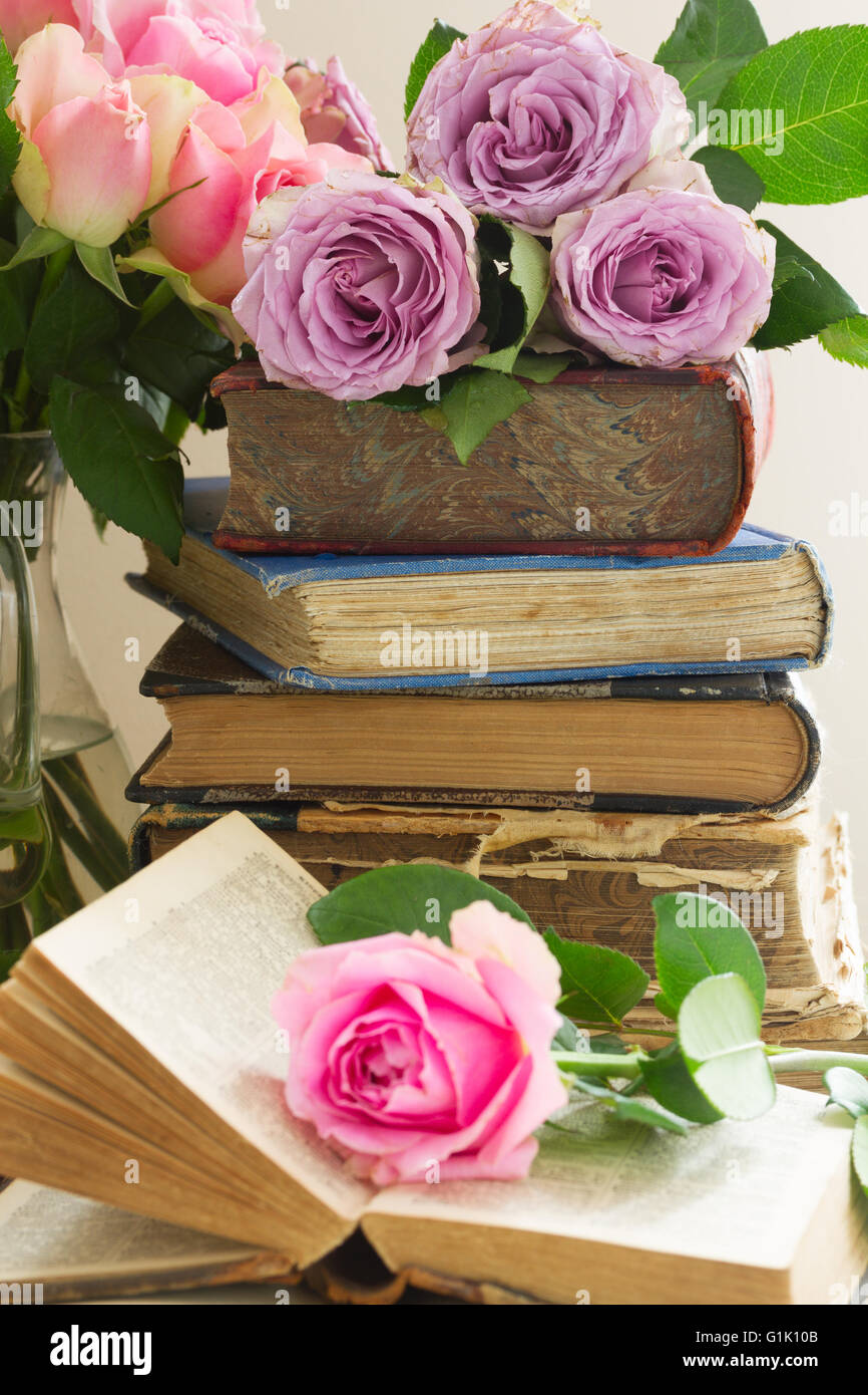 Old books with rose flower Stock Photo - Alamy