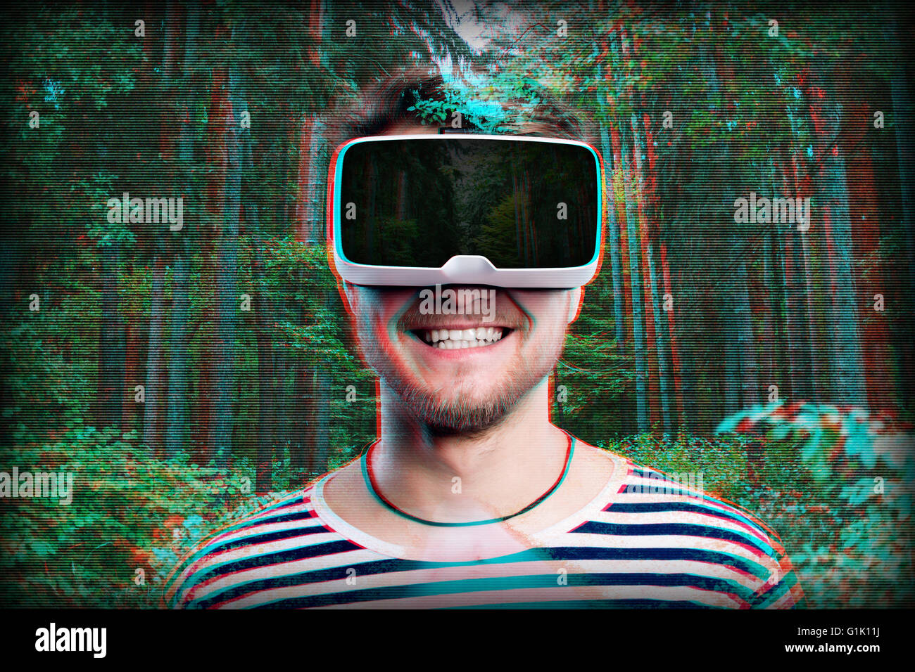 Man wearing virtual reality goggles. Green forest Stock Photo - Alamy