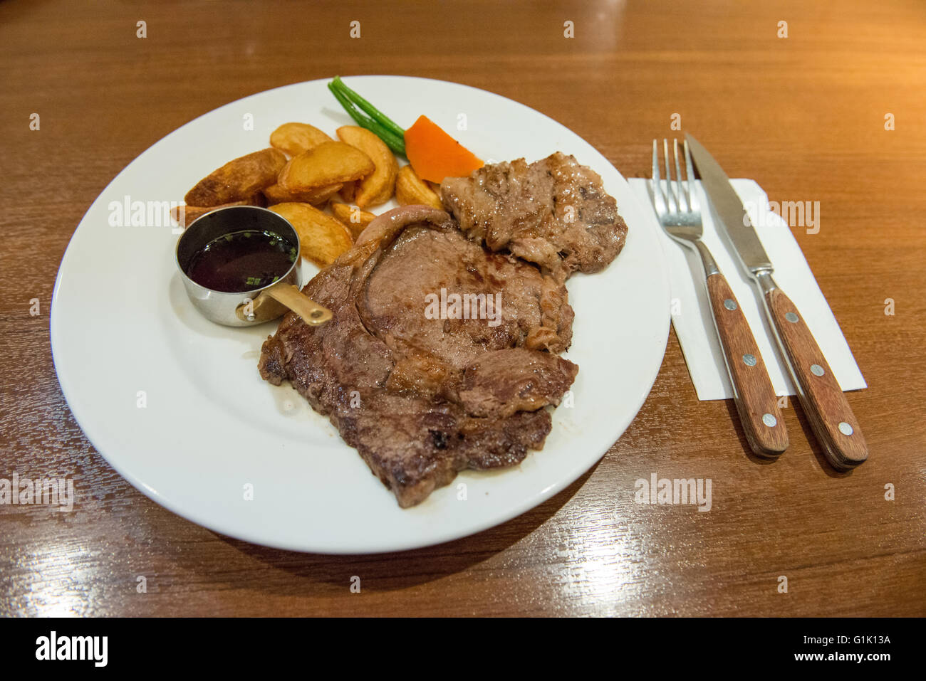 A large portion of beef steak and chips on plate Stock Photo - Alamy