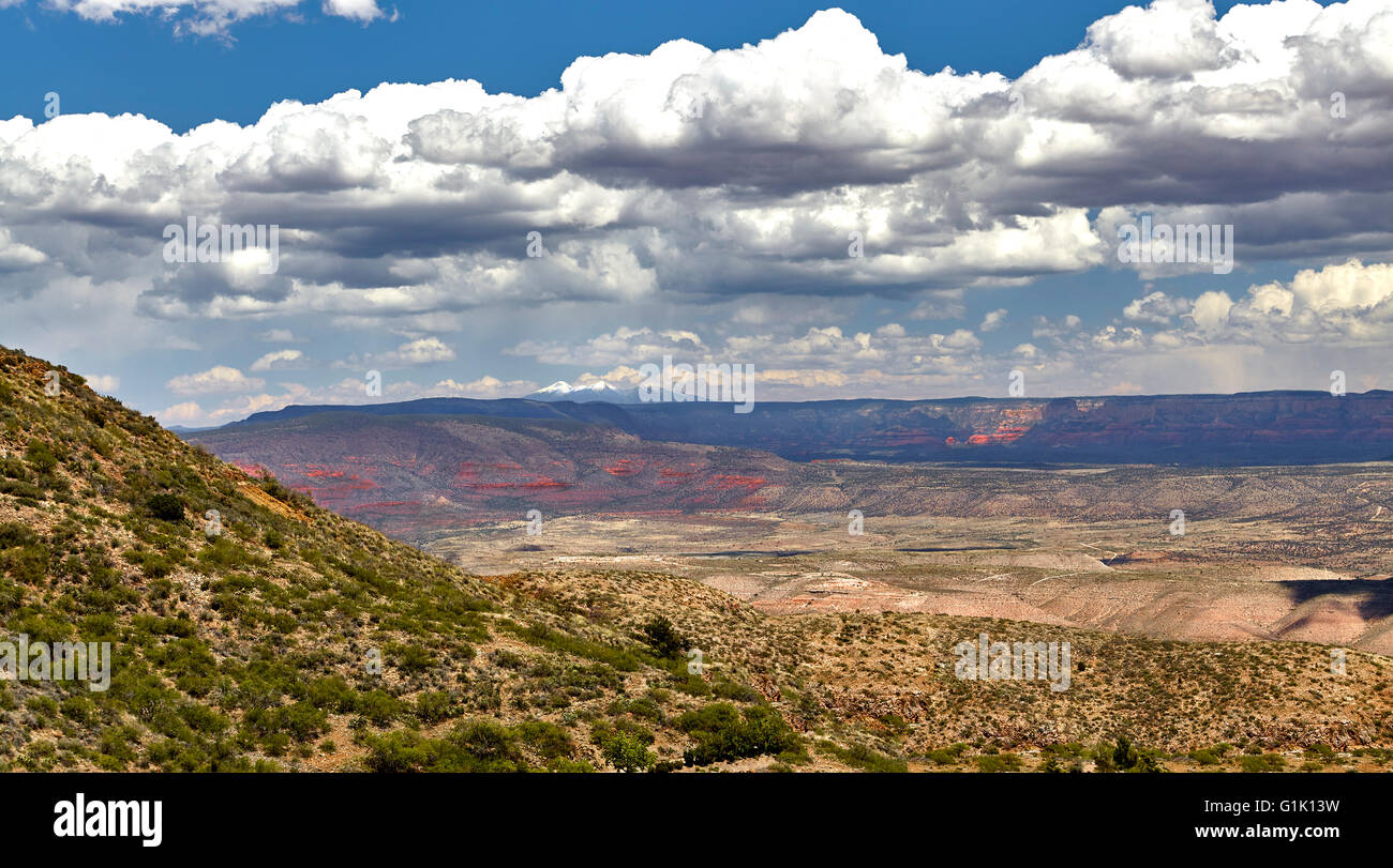 View of red rock mountains in Sedona Arizona with snow capped San Francisco Peaks in Flagstaff ...
