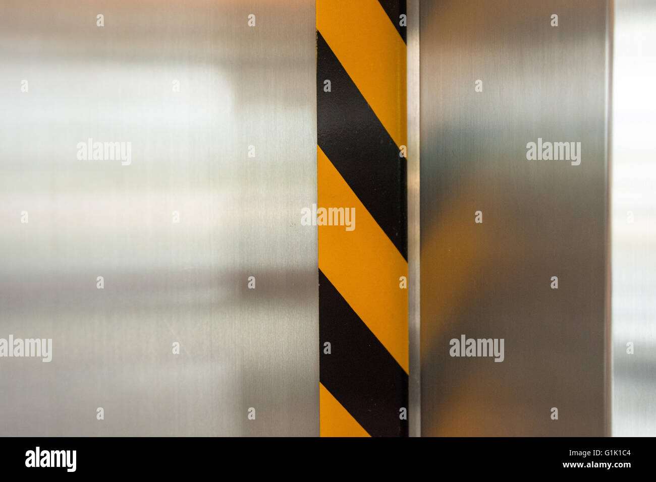 black and yellow lined sticker edge warning on elevator door Stock ...
