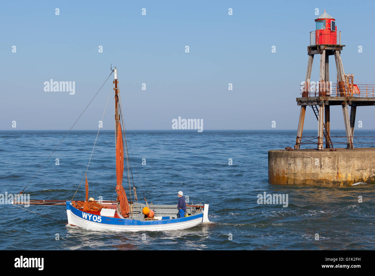A boat setting sail for the North Sea from Whitby Harbour Stock Photo ...