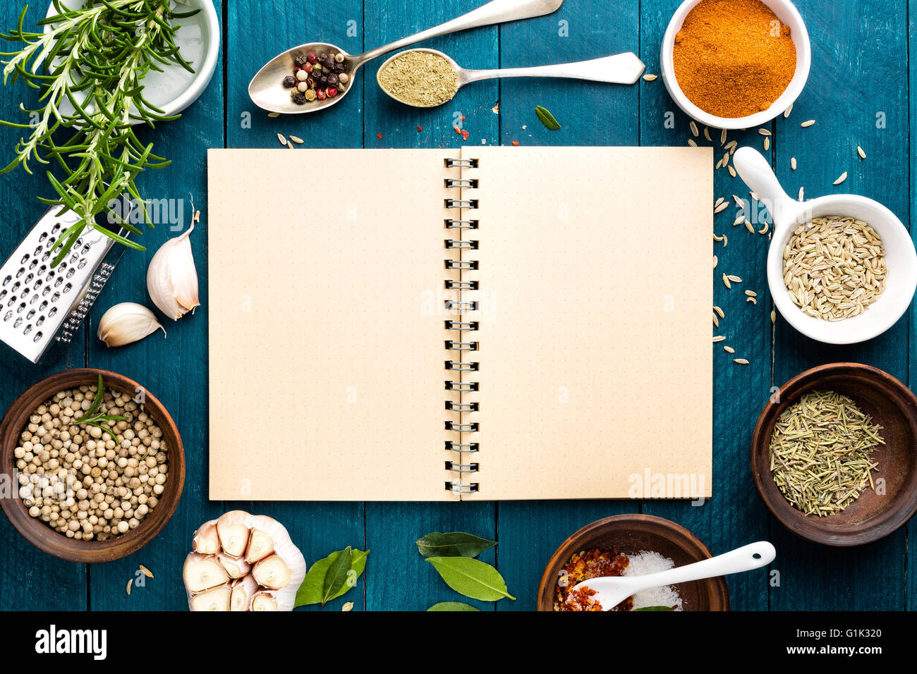 culinary background and recipe book with various spices on wooden table ...