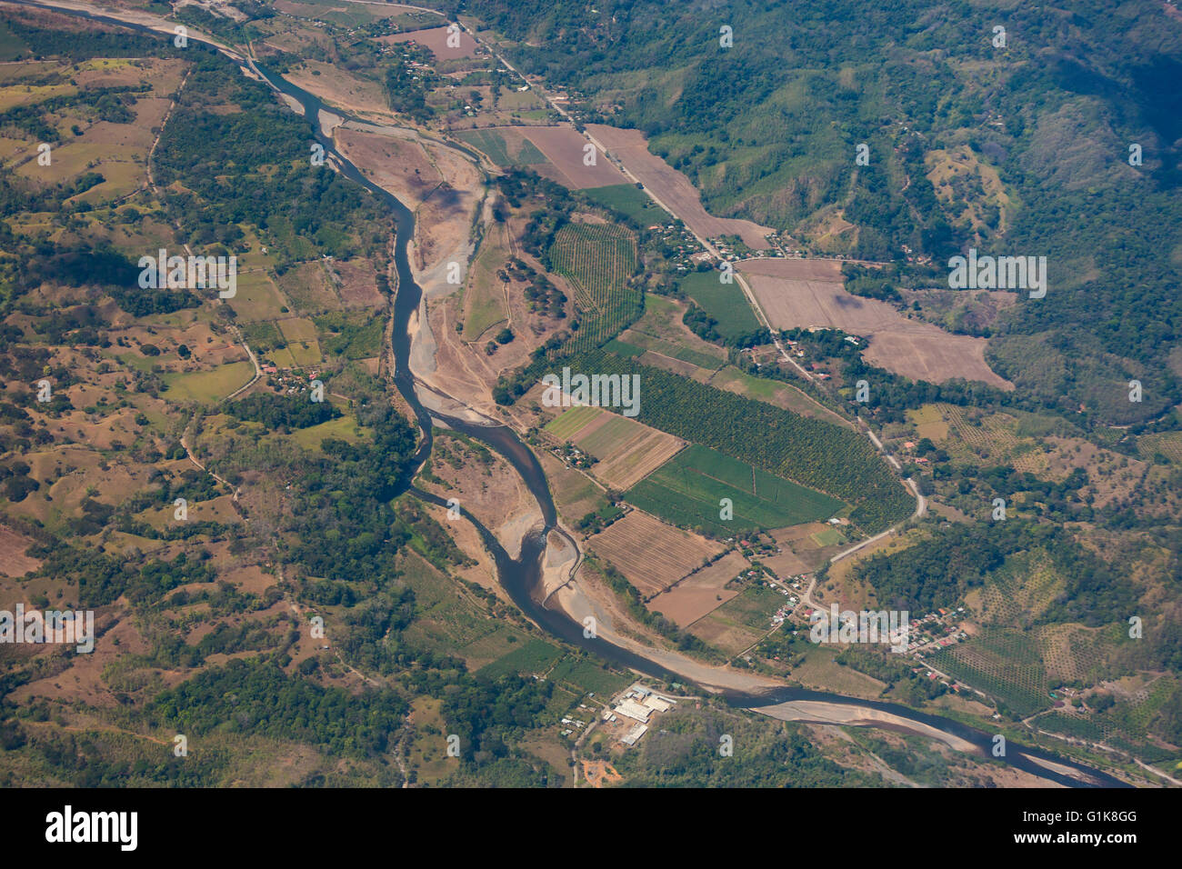 COSTA RICA - Aerial view of landscape along river with cleared fields ...
