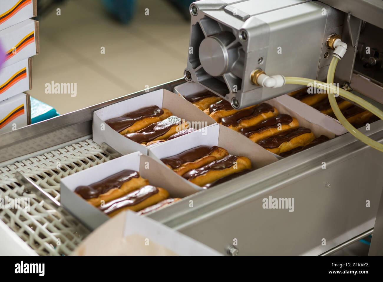 Boxes with chocolate eclairs Stock Photo - Alamy