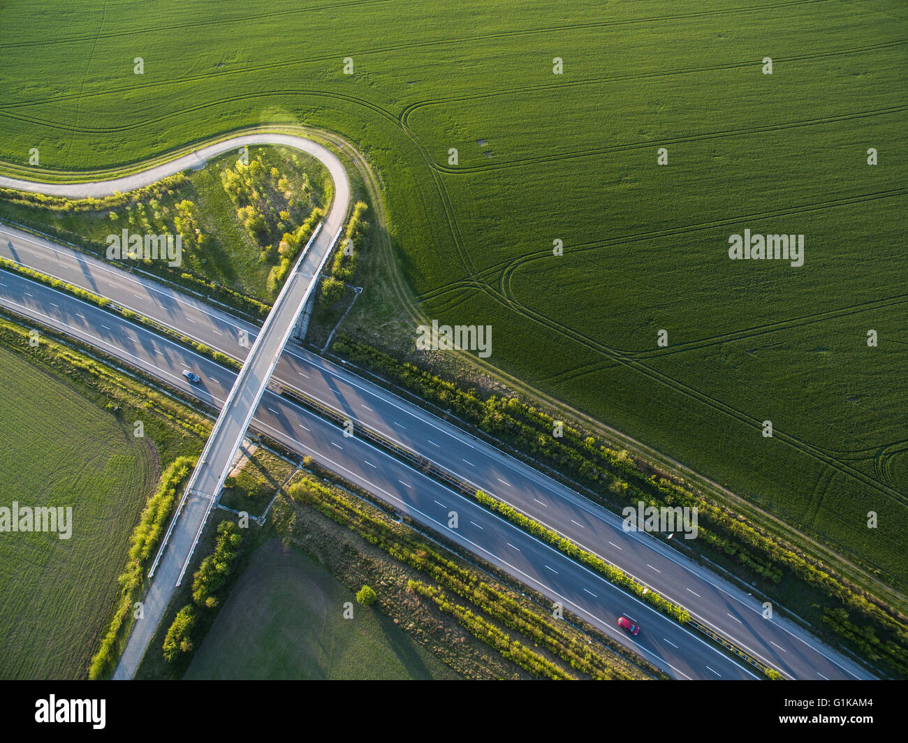 Aerial view of a highway amid fields with cars on it Stock Photo - Alamy