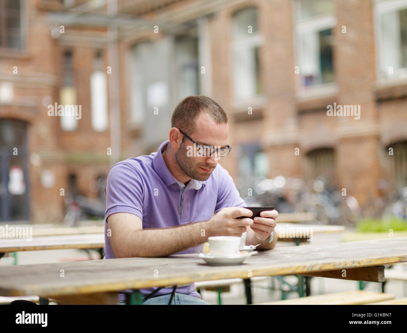 Man is using phone outside Stock Photo - Alamy