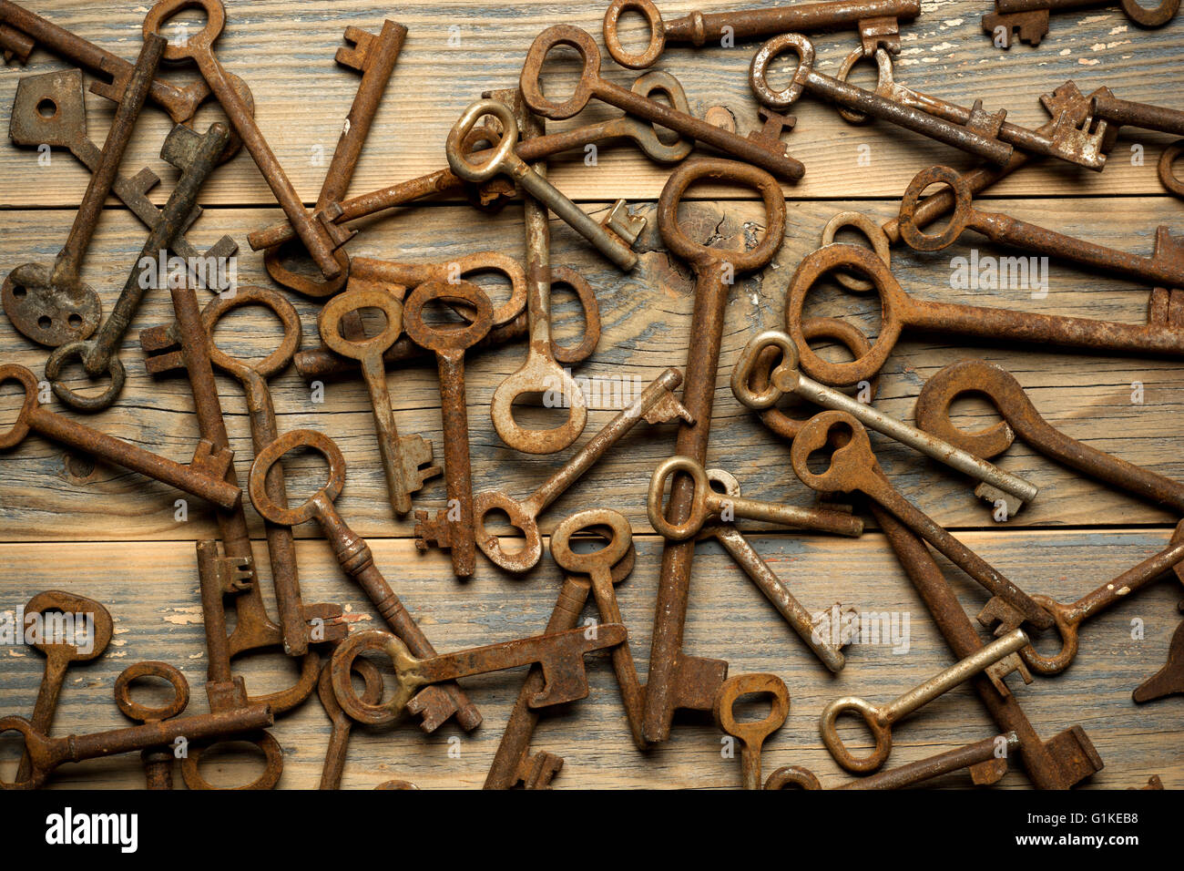 Many old keys on a well used wooden desk Stock Photo - Alamy